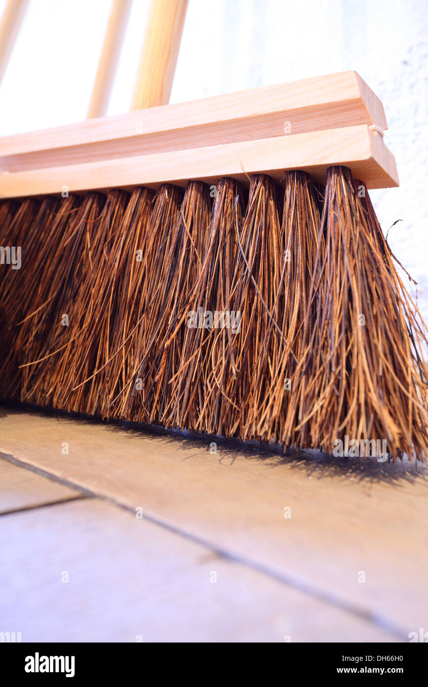 Close up large brooms for house work on old wooden floor of country ...