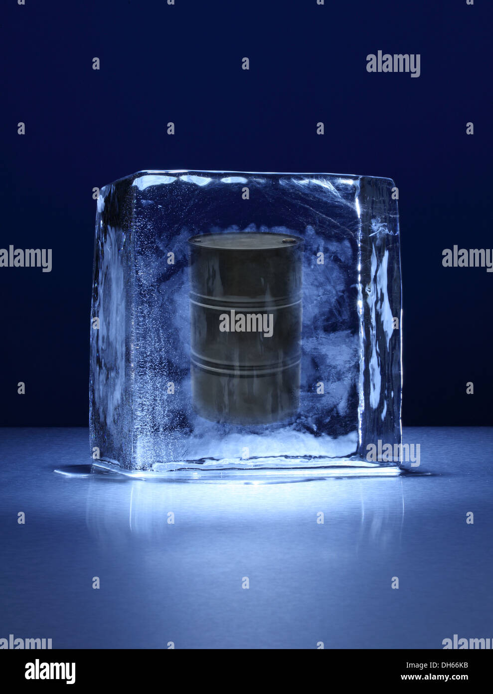 A black oil barrel frozen in a clear block of ice Stock Photo - Alamy