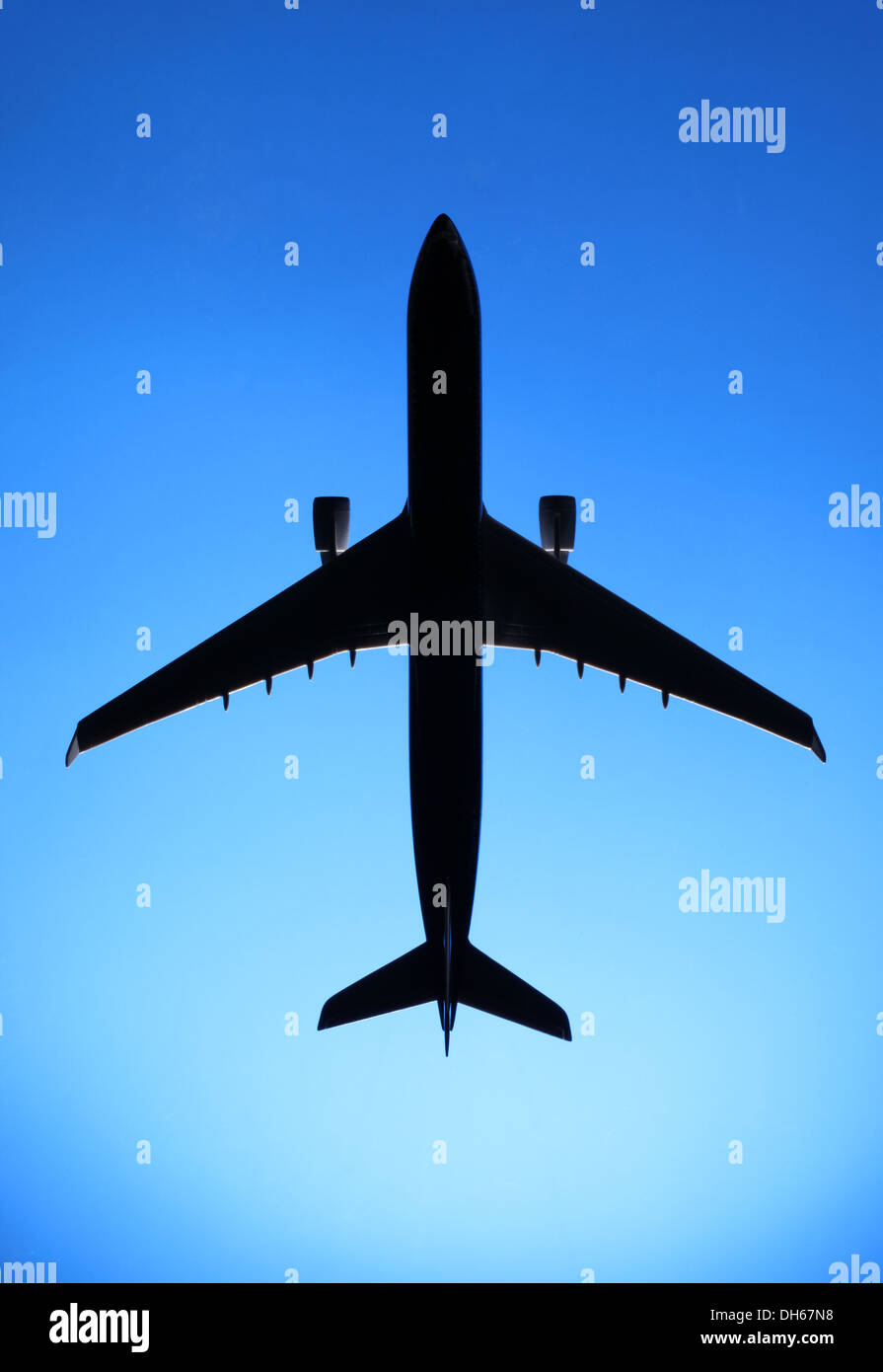 A plastic model of a commercial airplane airplane flying in blue sky ...