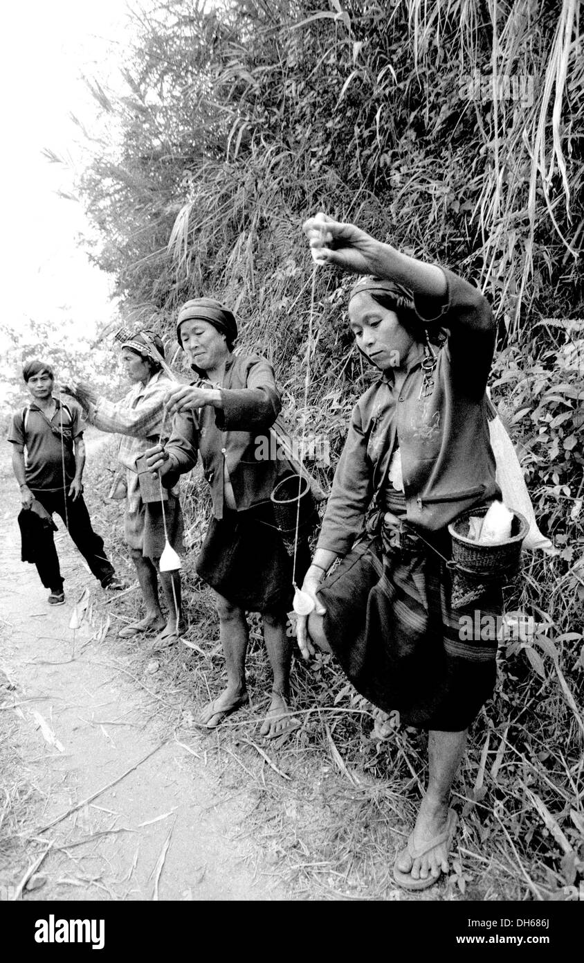 Women of the Akha tribe spinning cotton thread in the traditional way ...