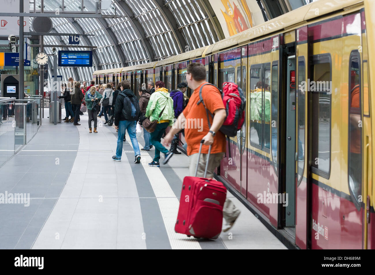 Passengers leave the train at the railway station platform. Berlin ...