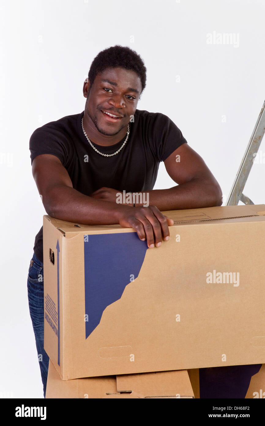 Young black man with moving boxes Stock Photo - Alamy