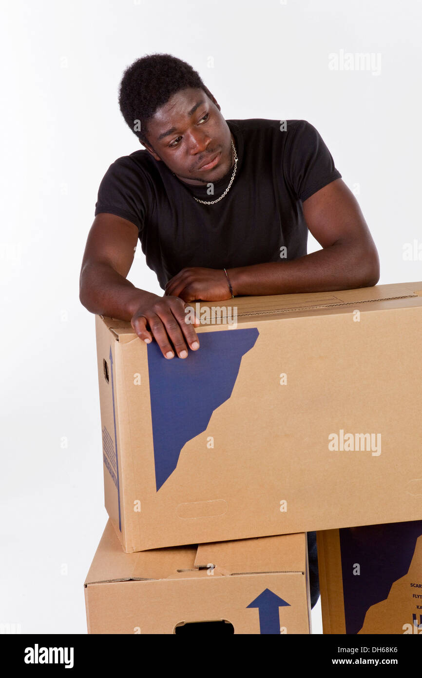 Young black man with moving boxes Stock Photo - Alamy