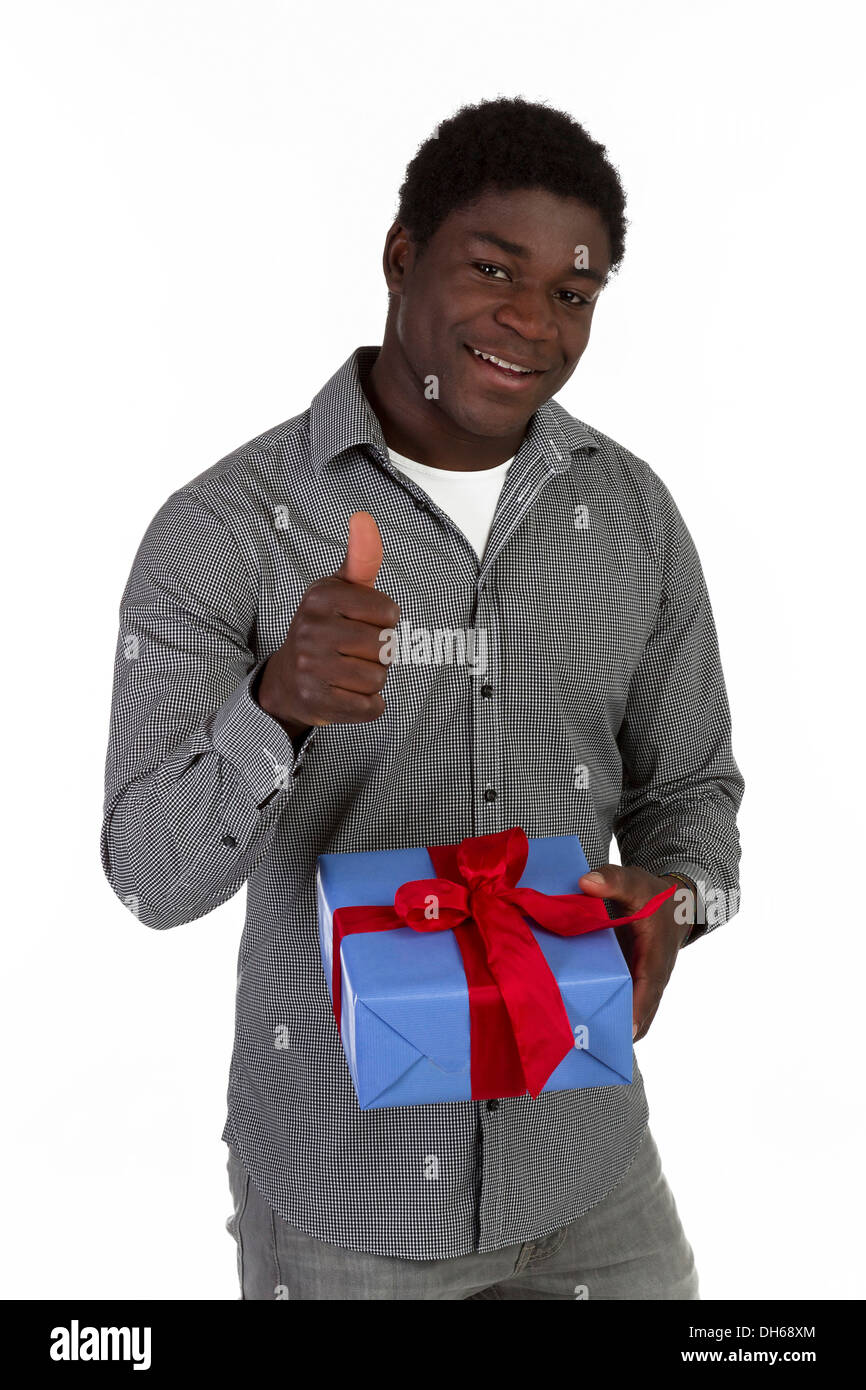 Young black man holding a present, thumbs up Stock Photo - Alamy