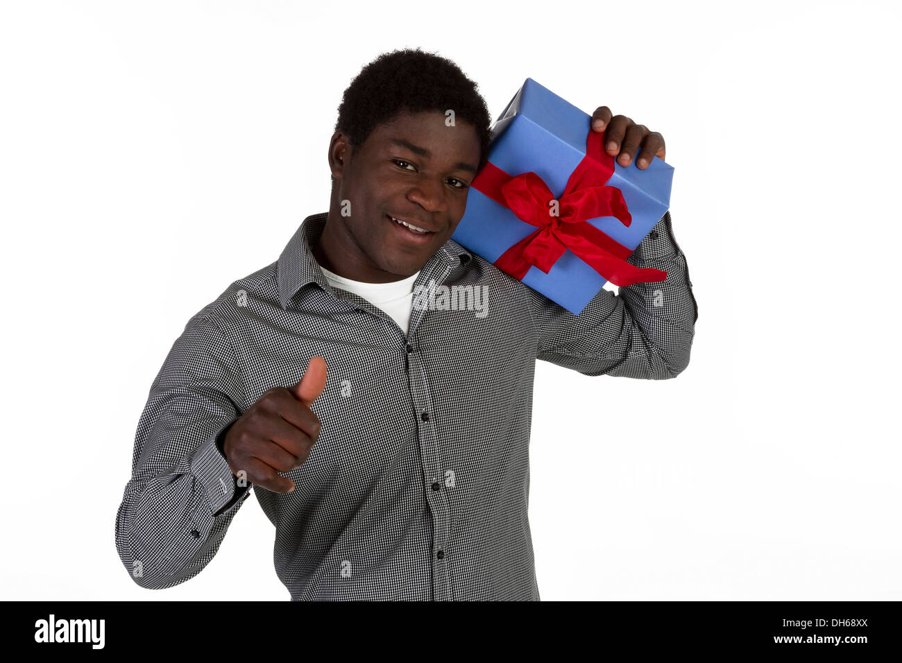 Young black man holding a present Stock Photo - Alamy