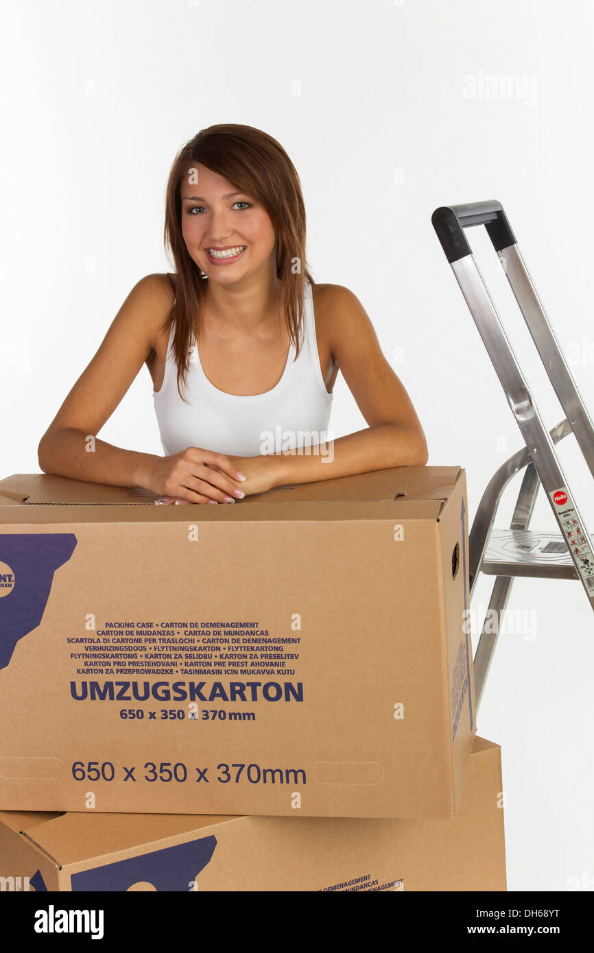 Young woman with moving boxes Stock Photo - Alamy