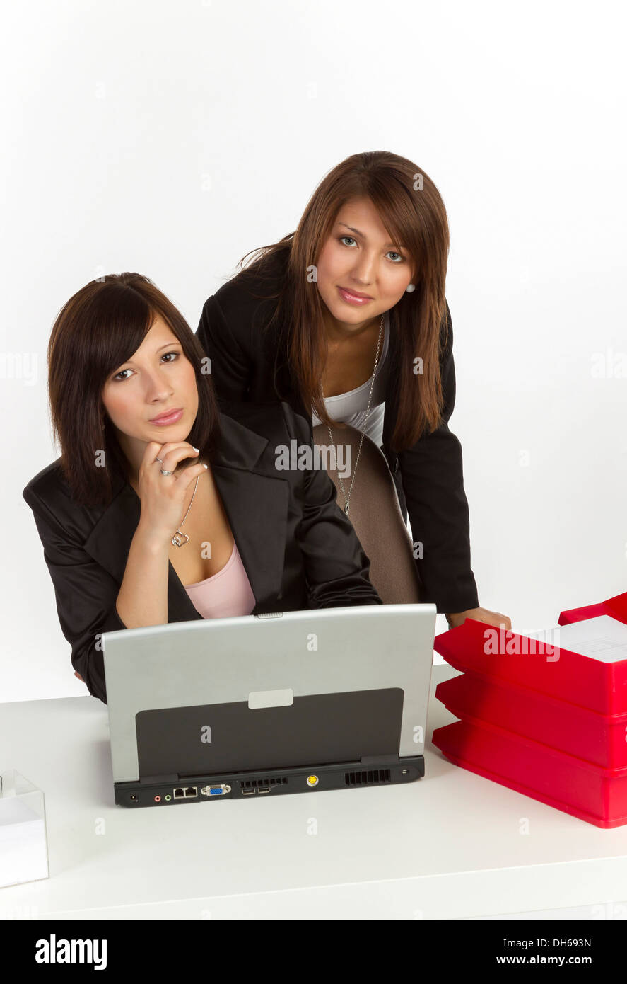 Two young women in an office Stock Photo - Alamy