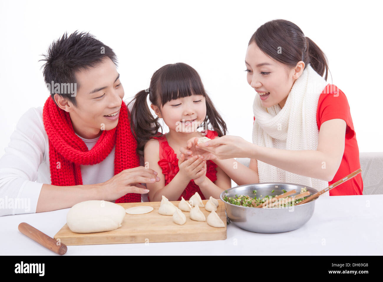 A family of three making dumplings to celebrate Spring Festival Stock ...