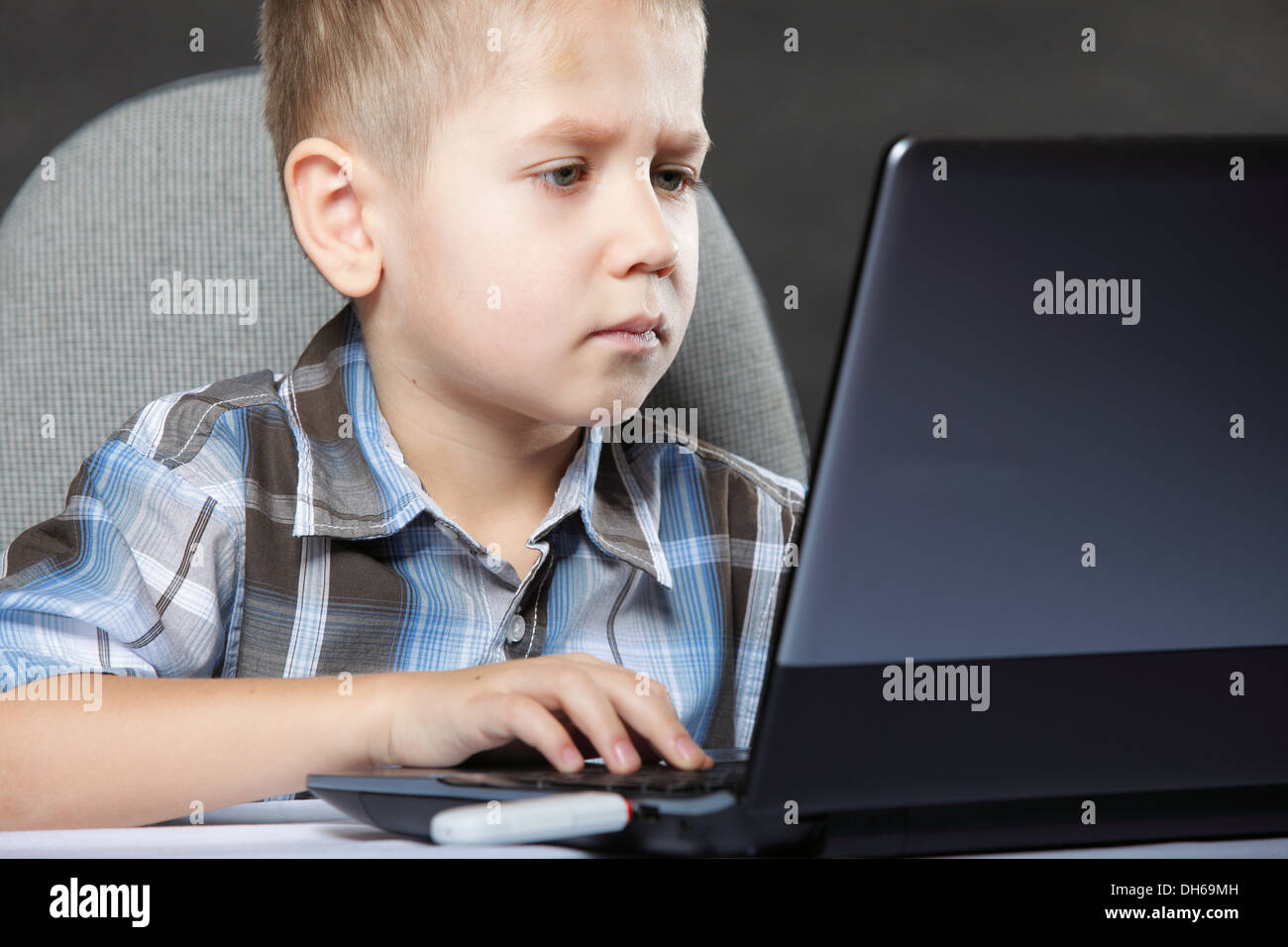 Computer addiction child boy with laptop notebook black background ...