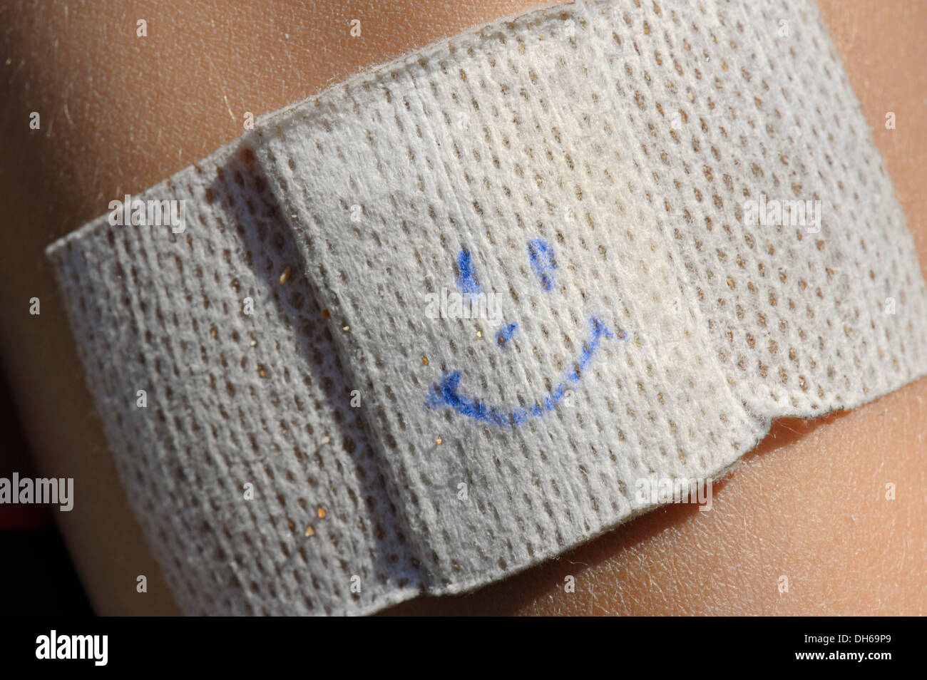 Plaster with a smiley face on a child's leg Stock Photo - Alamy