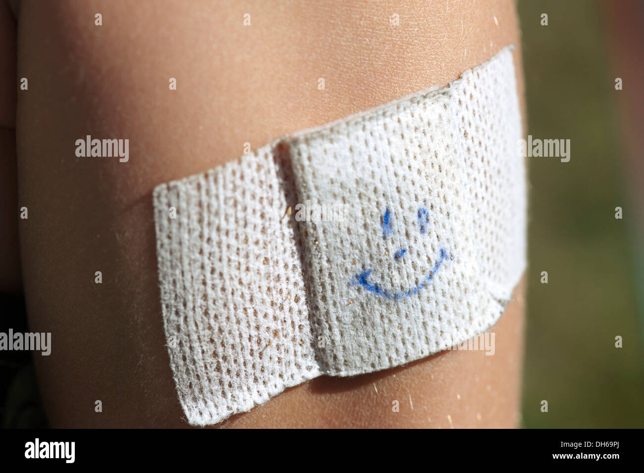 Plaster with a smiley face on a child's leg Stock Photo - Alamy
