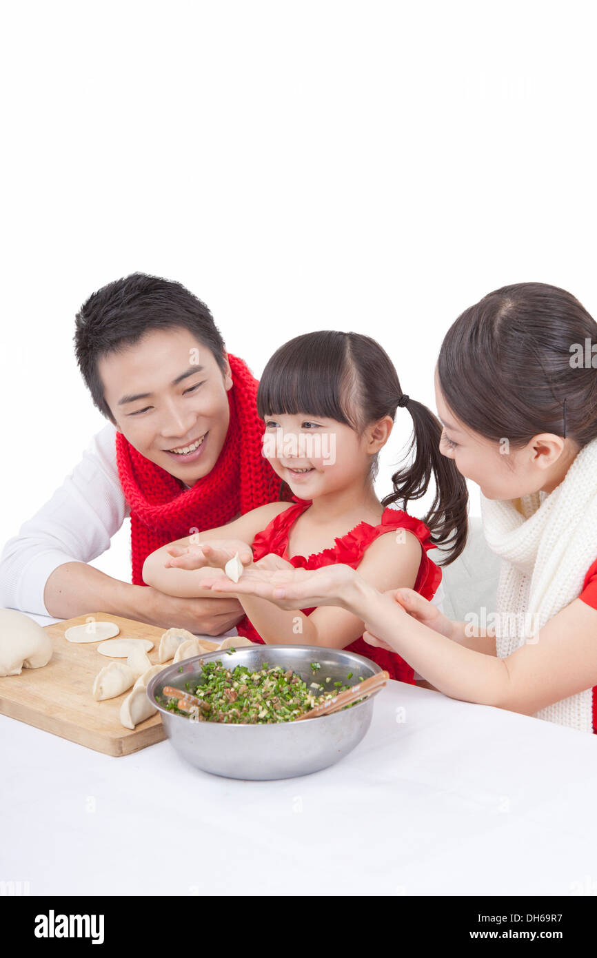 A family of three making dumplings to celebrate Spring Festival Stock ...