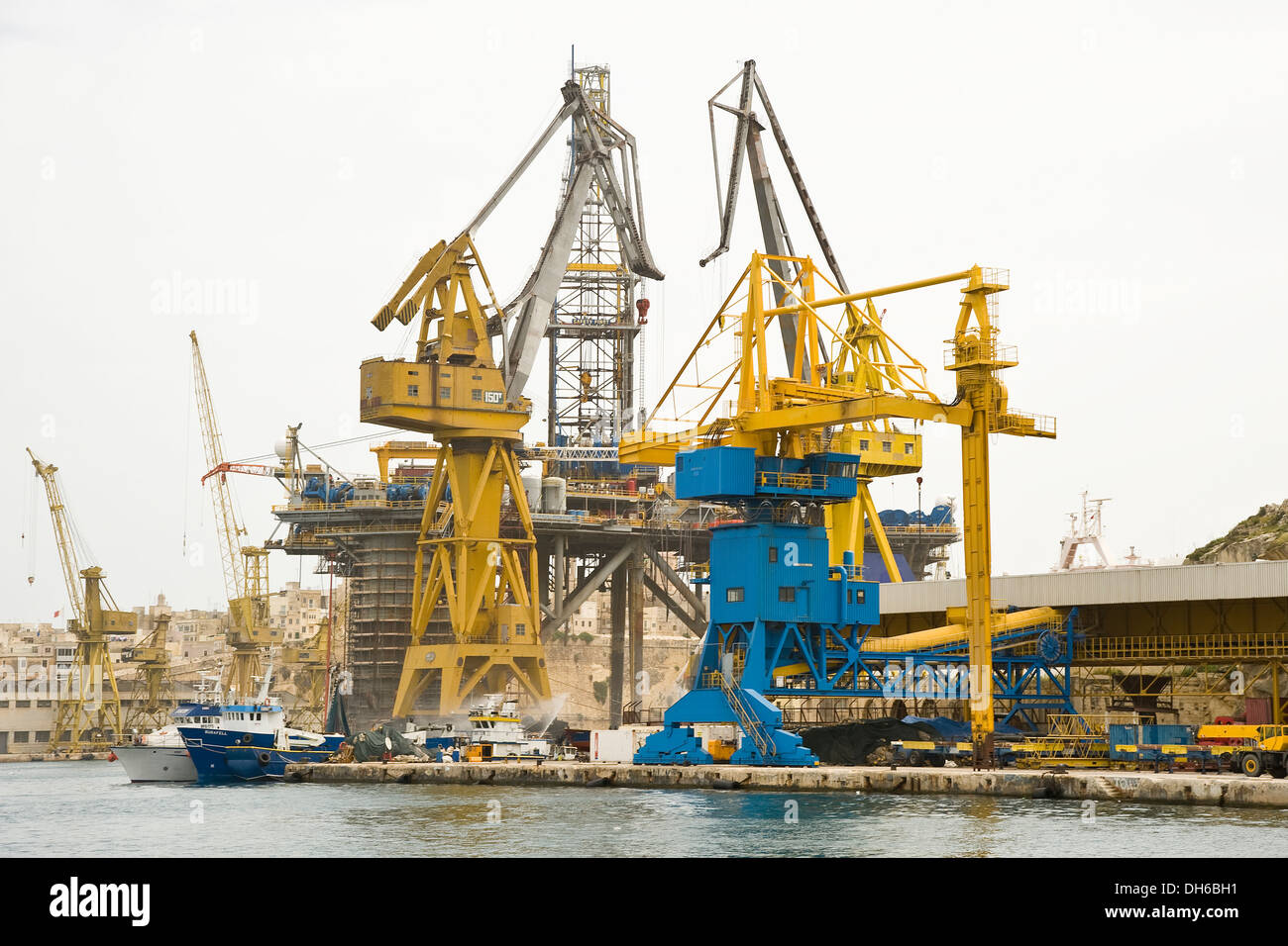 Malta, jewel of the Mediterranean. An oil rig and cranes at work in ...