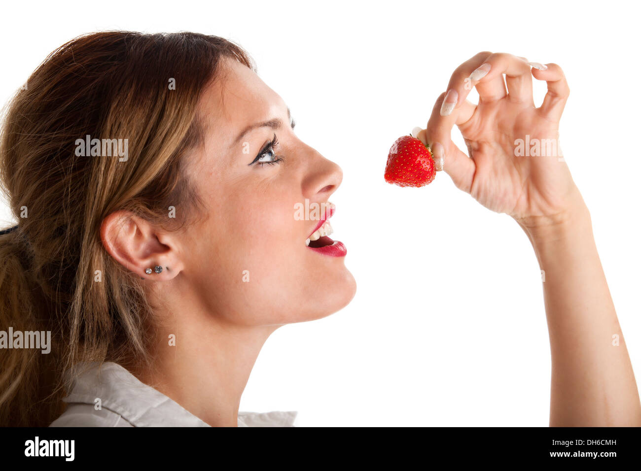 woman eating a strawberry Stock Photo - Alamy