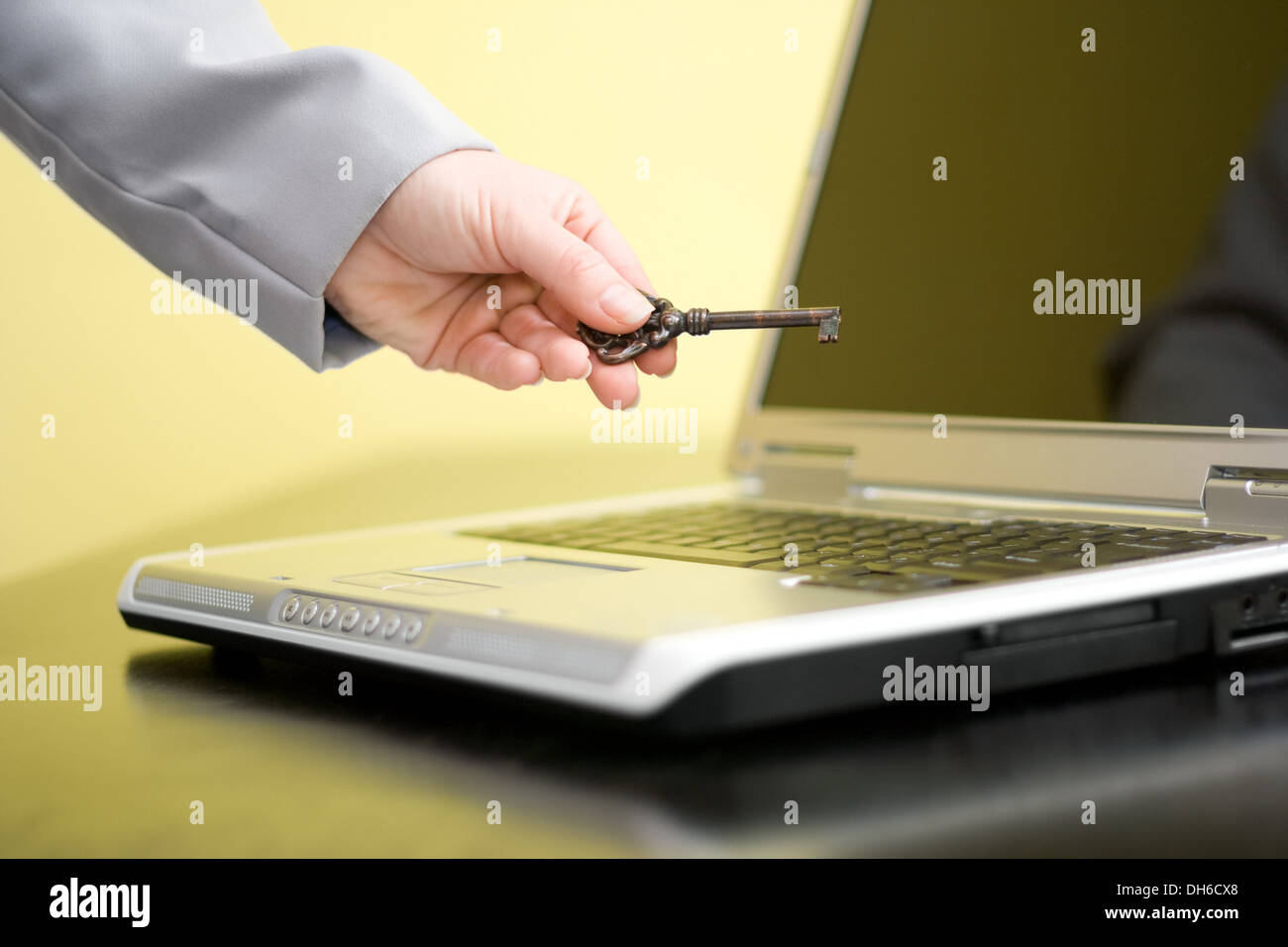Hand showing the key to success in front of a laptop computer Stock ...