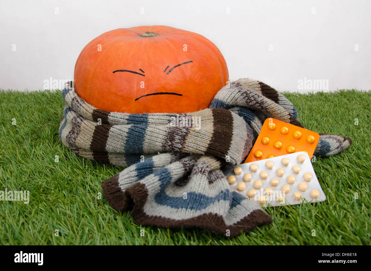 Sick pumpkin wrapped in a scarf Stock Photo - Alamy