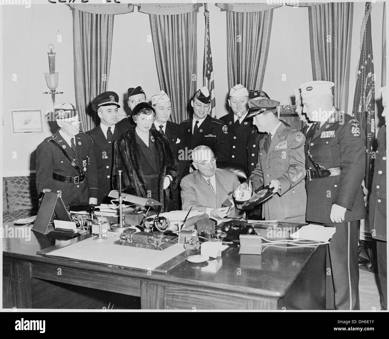 A photograph of President Harry S. Truman in the Oval Office, receiving ...