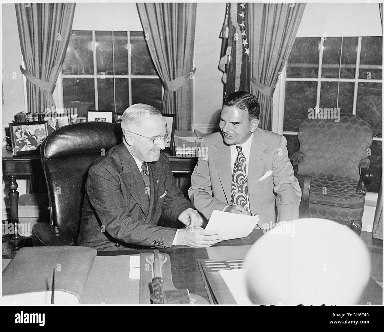 This photograph shows President Harry S. Truman conferring with former ...