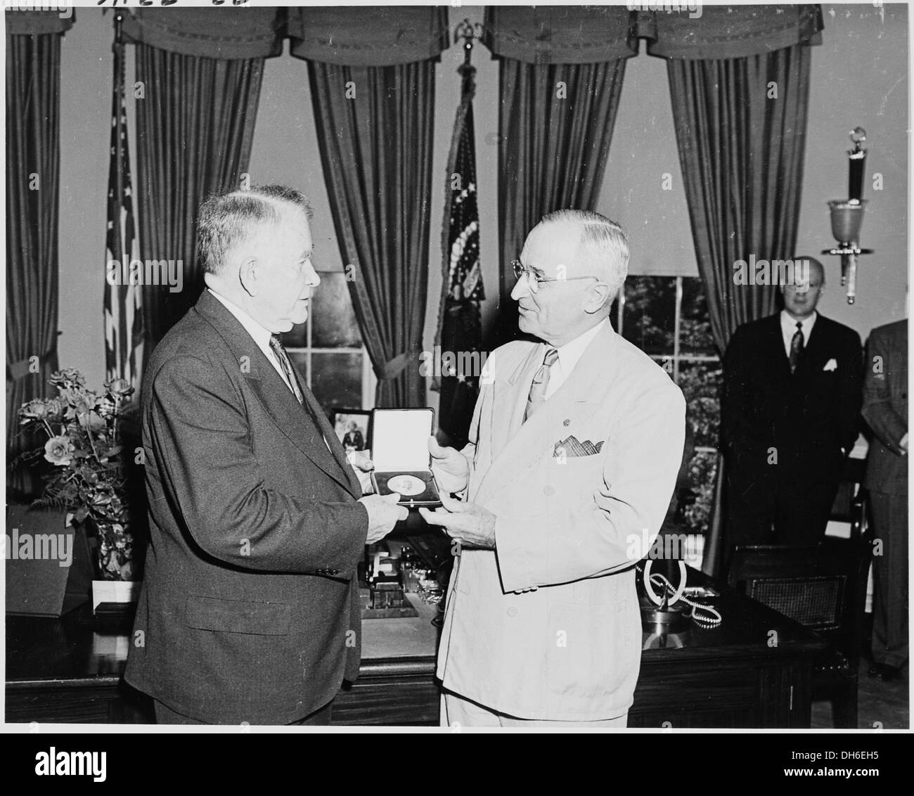 A photograph of President Harry S. Truman presenting a Congressional ...