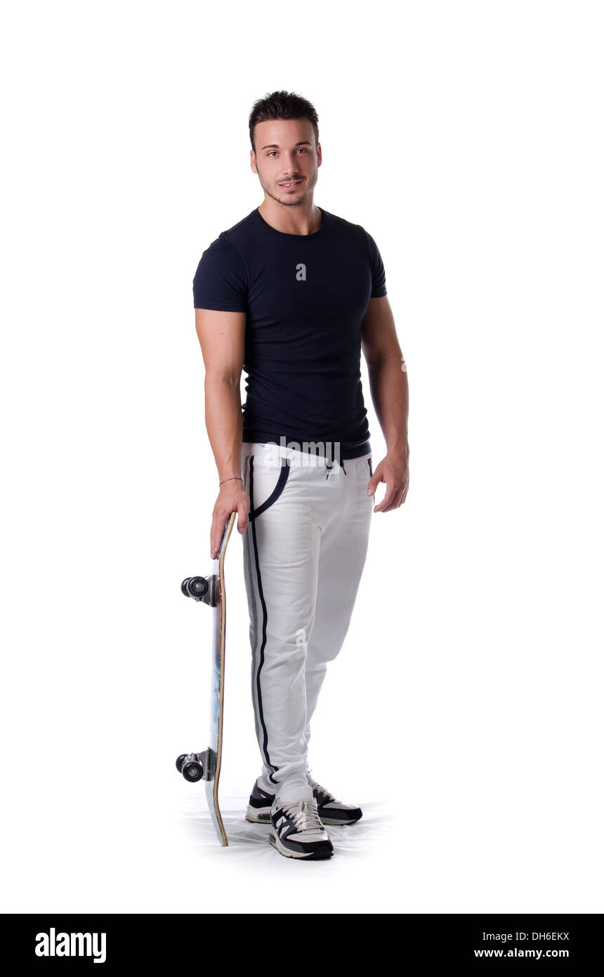 Full figure shot of handsome, smiling young man with skateboard ...