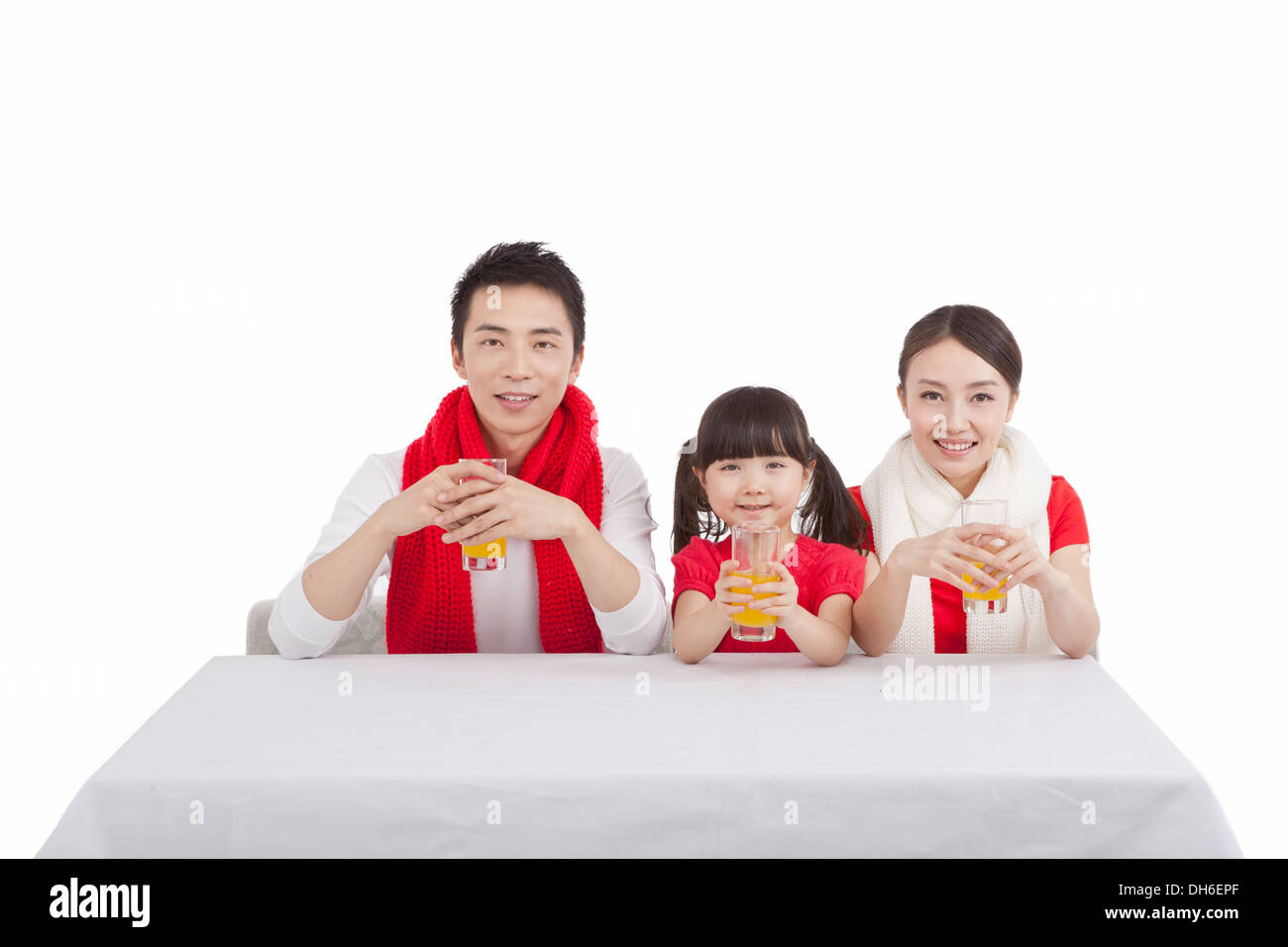 A family of three drink juice Stock Photo - Alamy
