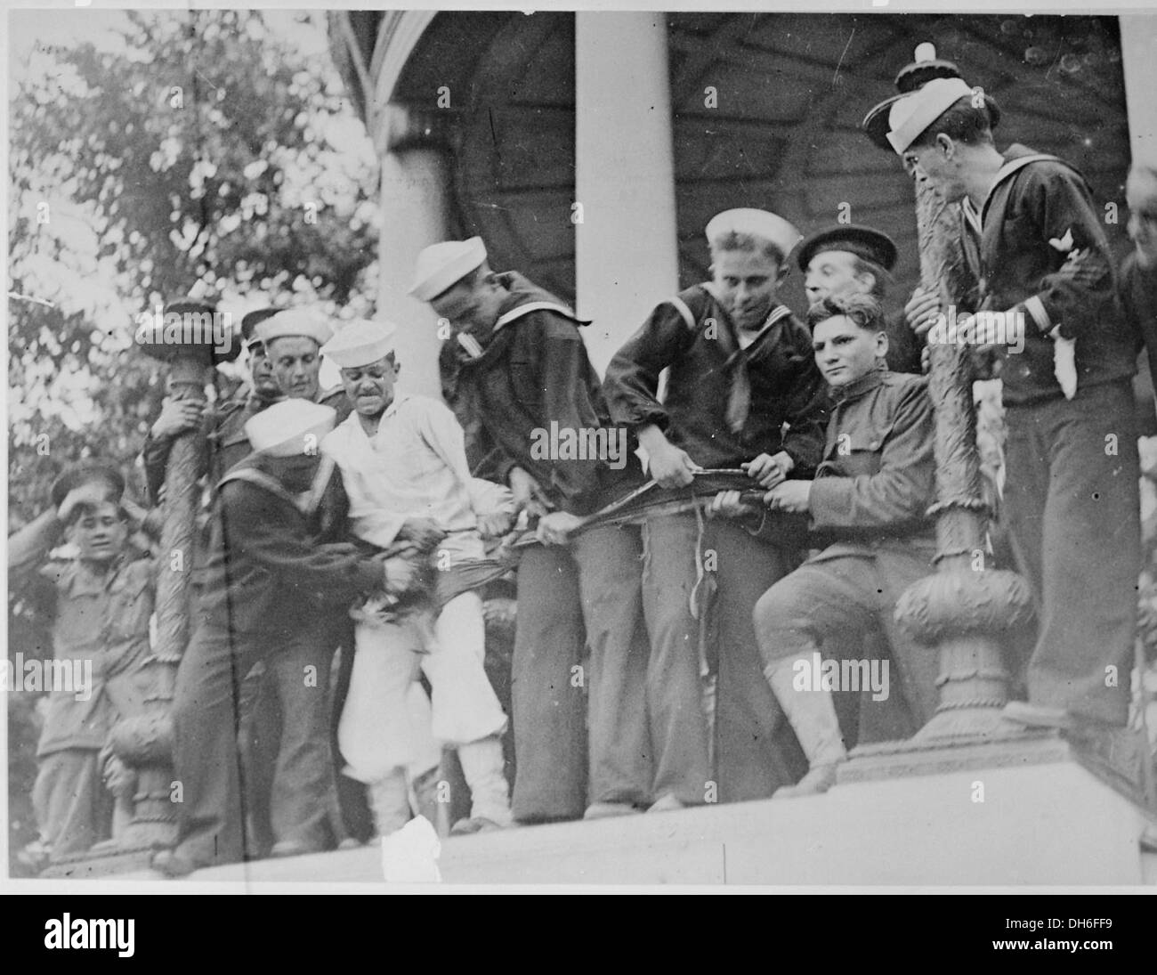 Soldiers and sailors tear up a flag during a socialist peace ...