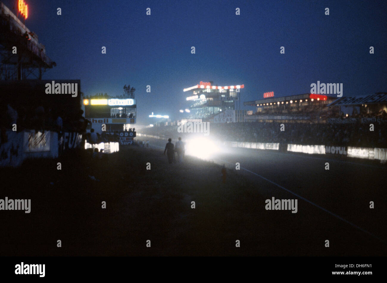 Cars racing up the start finish straight at night, 24 hours race at Le ...