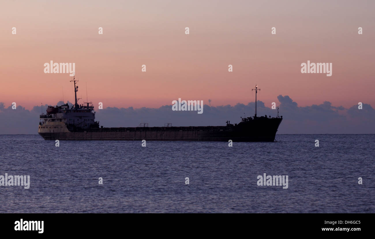 view on cargo ship at sunrise Stock Photo - Alamy