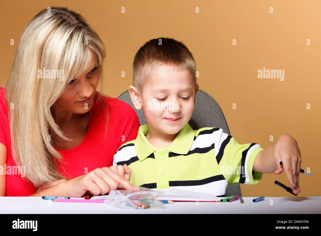 mother and son drawing together, mom helping with homework orange ...
