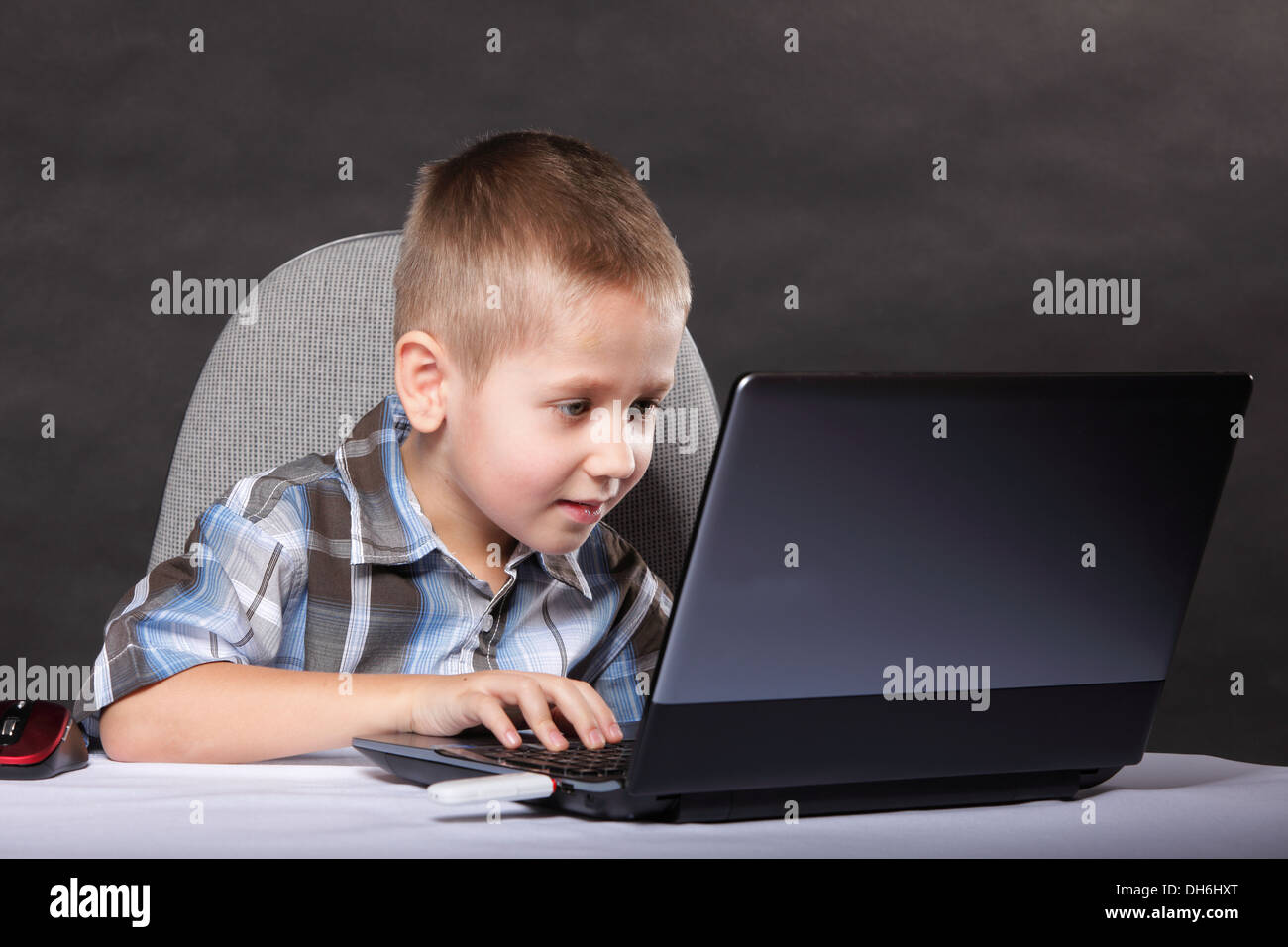 Computer addiction child boy with laptop notebook black background ...