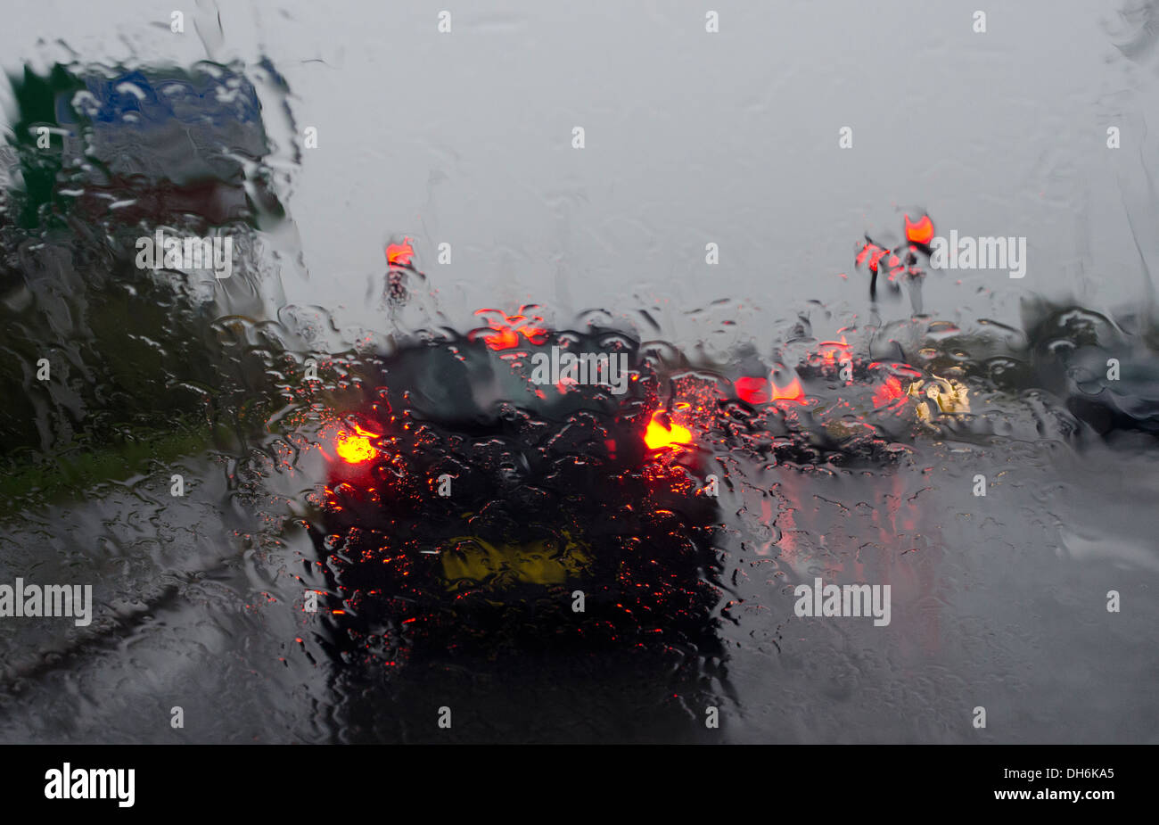 View through the front wet windscreen of a car during heavy rain ...