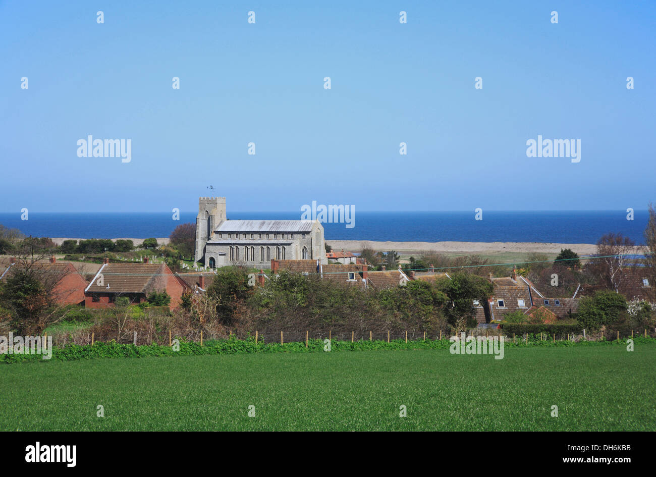 A view of the church of St Nicholas with the sea beyond at the village ...