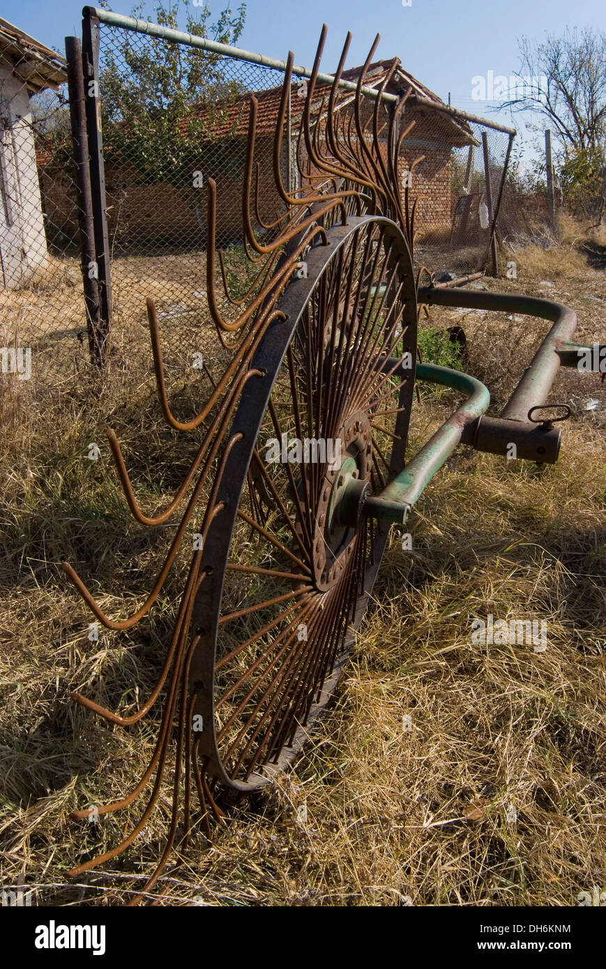 Farm machine by the road side rural village Stock Photo - Alamy