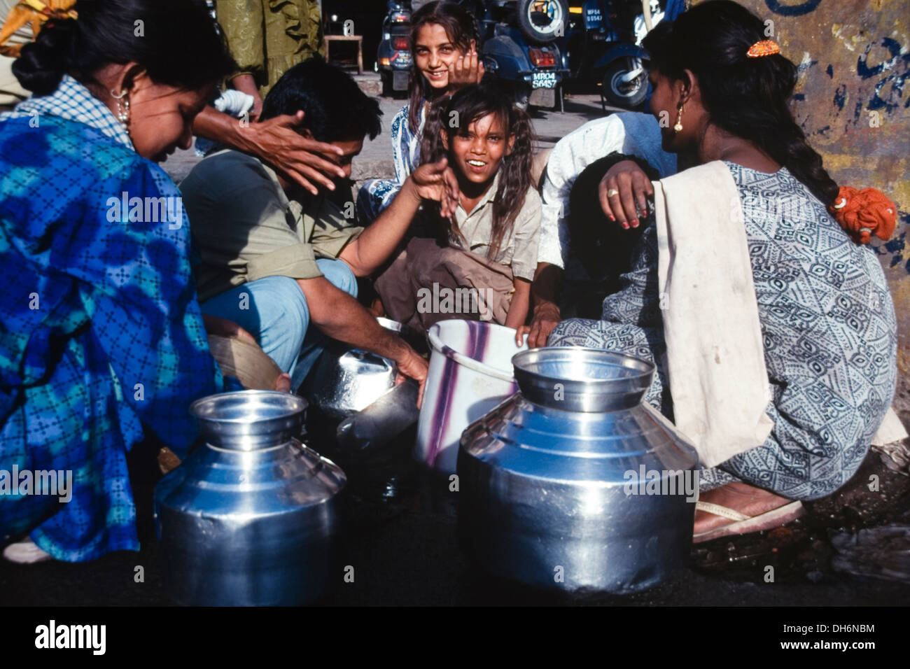 local women and children collecting fresh water from a public standpipe ... local women and children collecting fresh water from a public standpipe ...