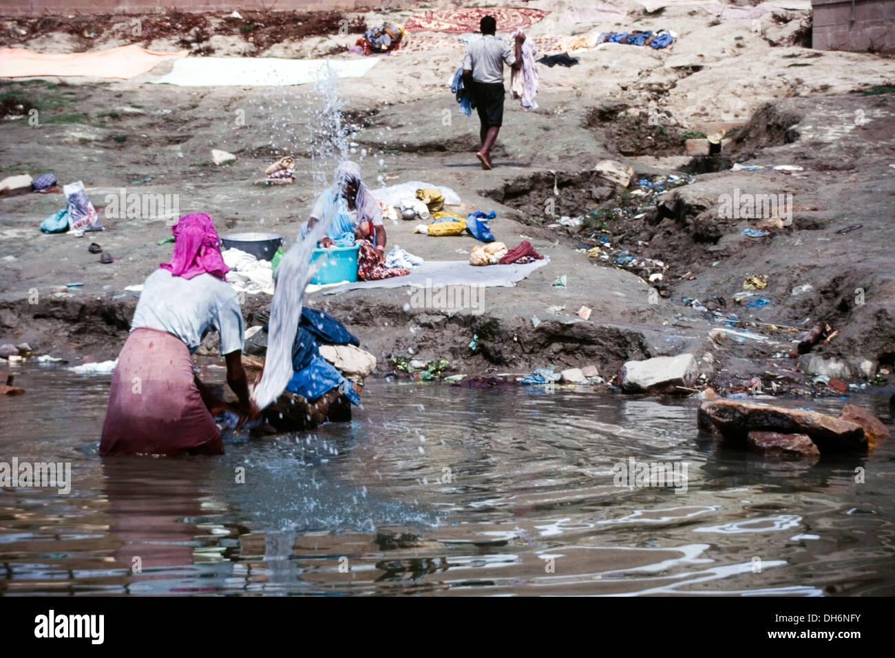 local woman doing the laundry outside in public river ganges india ...