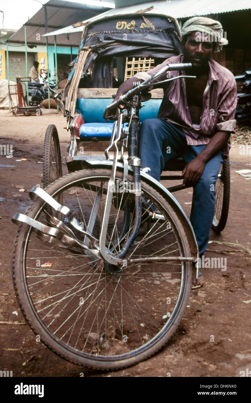 rickshaw owner waits for passengers in indian town Stock Photo - Alamy