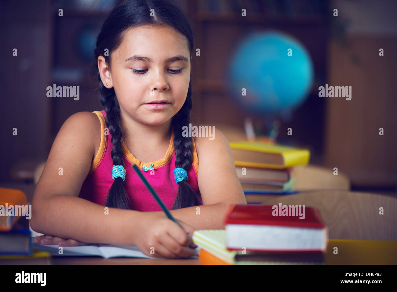 Indian girl writing in notebook hi-res stock photography and images - Alamy