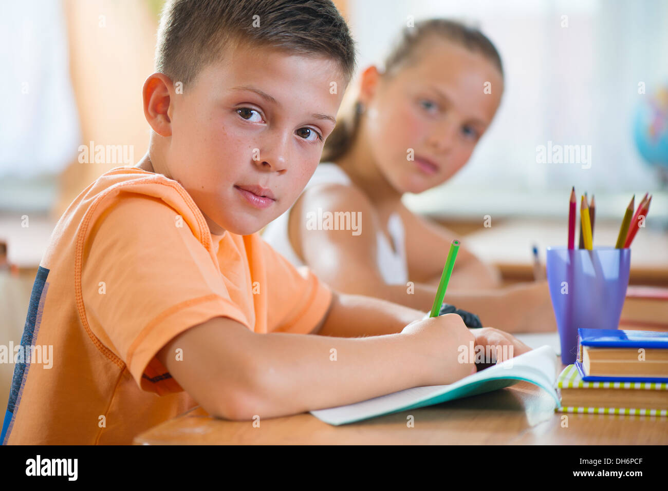 Cute schoolchildren during lesson in classroom at school Stock Photo ...