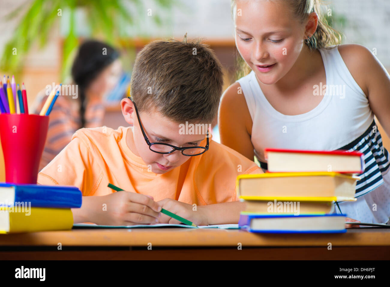 Cute schoolchildren during lesson in classroom at school Stock Photo ...