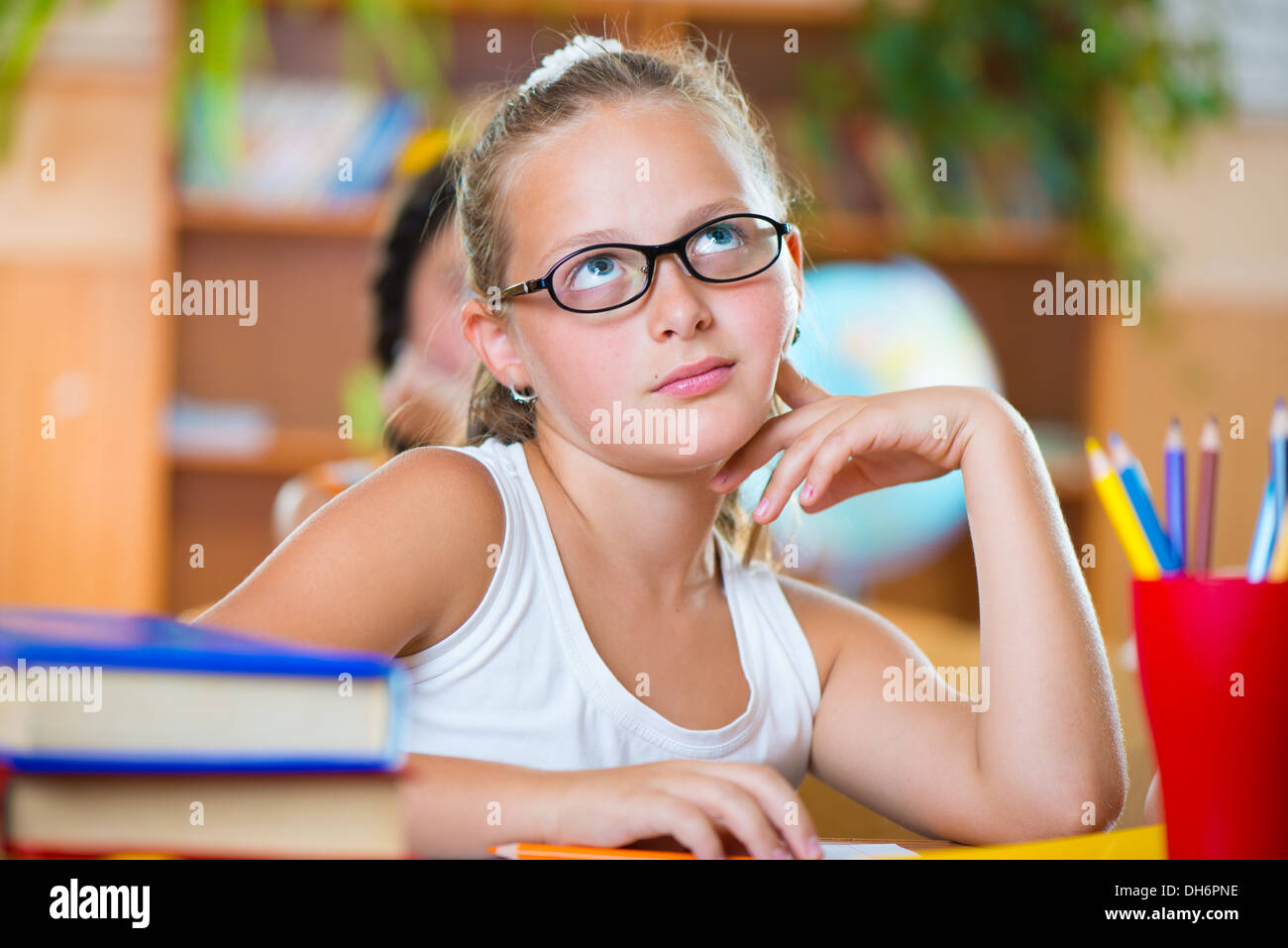 Cute girl studying in classroom at school Stock Photo - Alamy