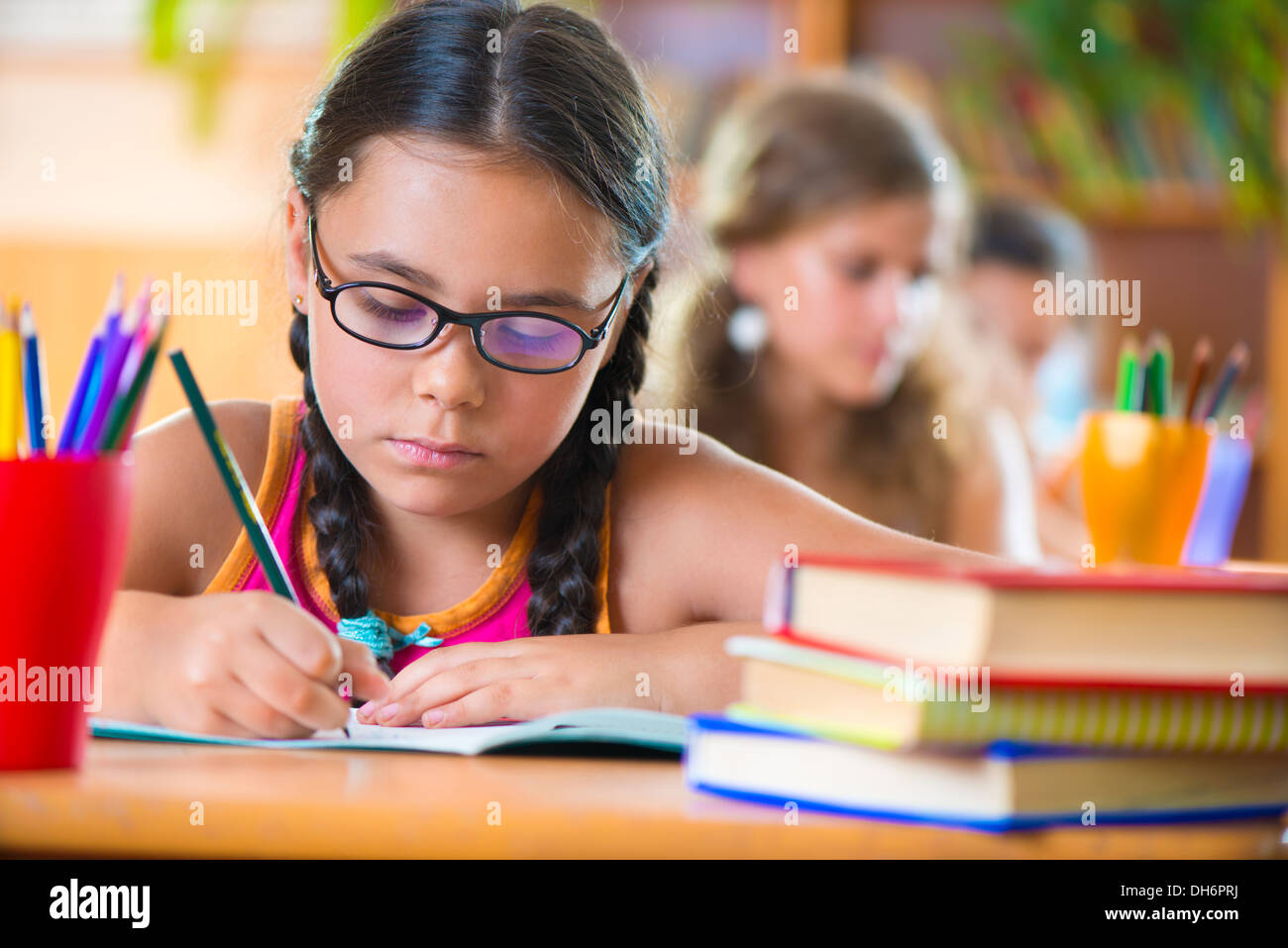 Cute girl studying in classroom at school Stock Photo - Alamy