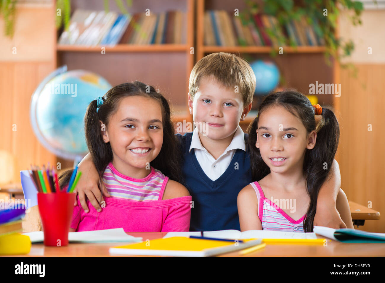Portrait of smart schoolchildren looking at camera in classroom Stock ...