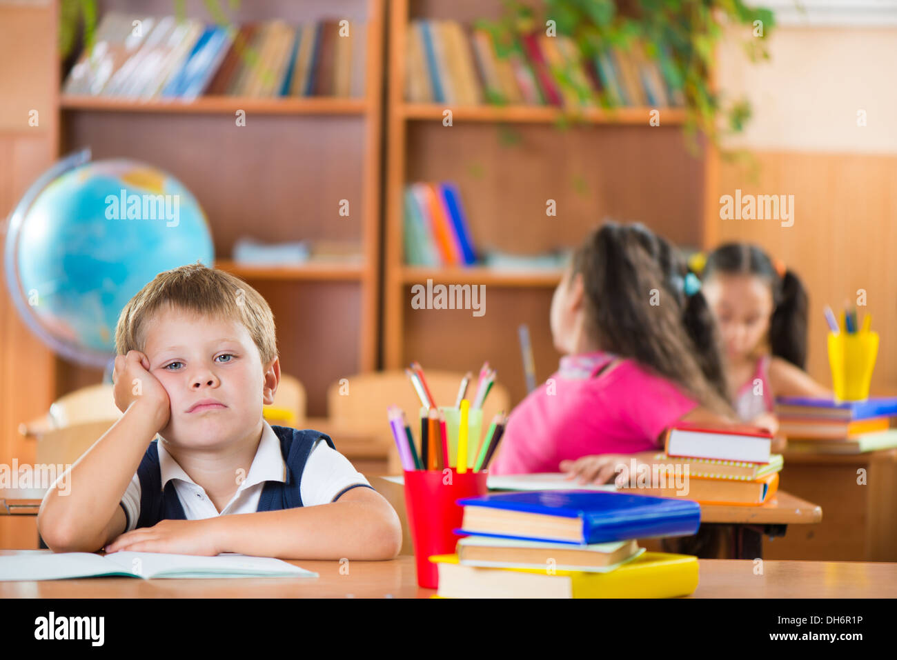 Cute schoolchildren during lesson in classroom at school Stock Photo ...