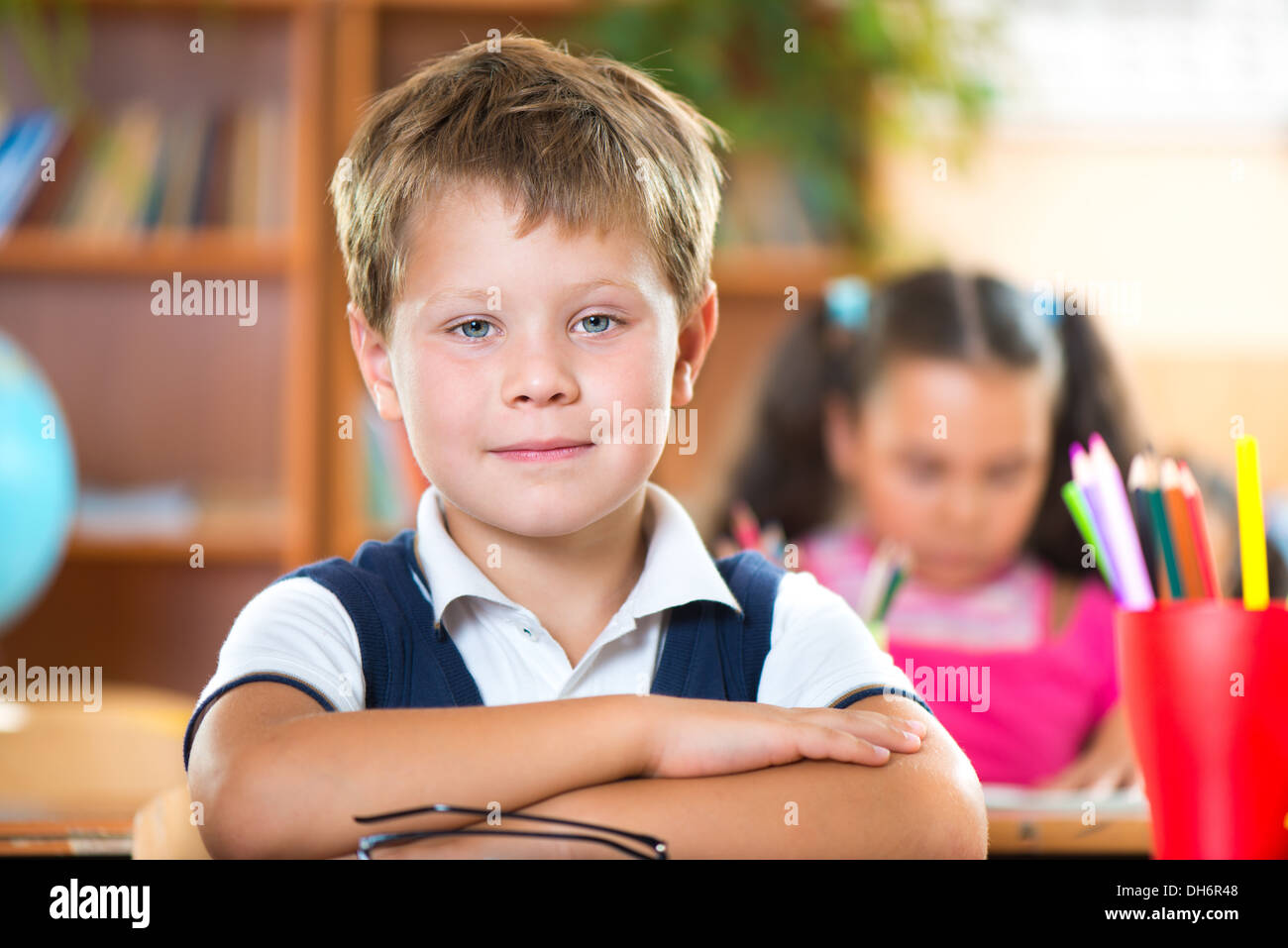 Cute schoolchildren during lesson in classroom at school Stock Photo ...
