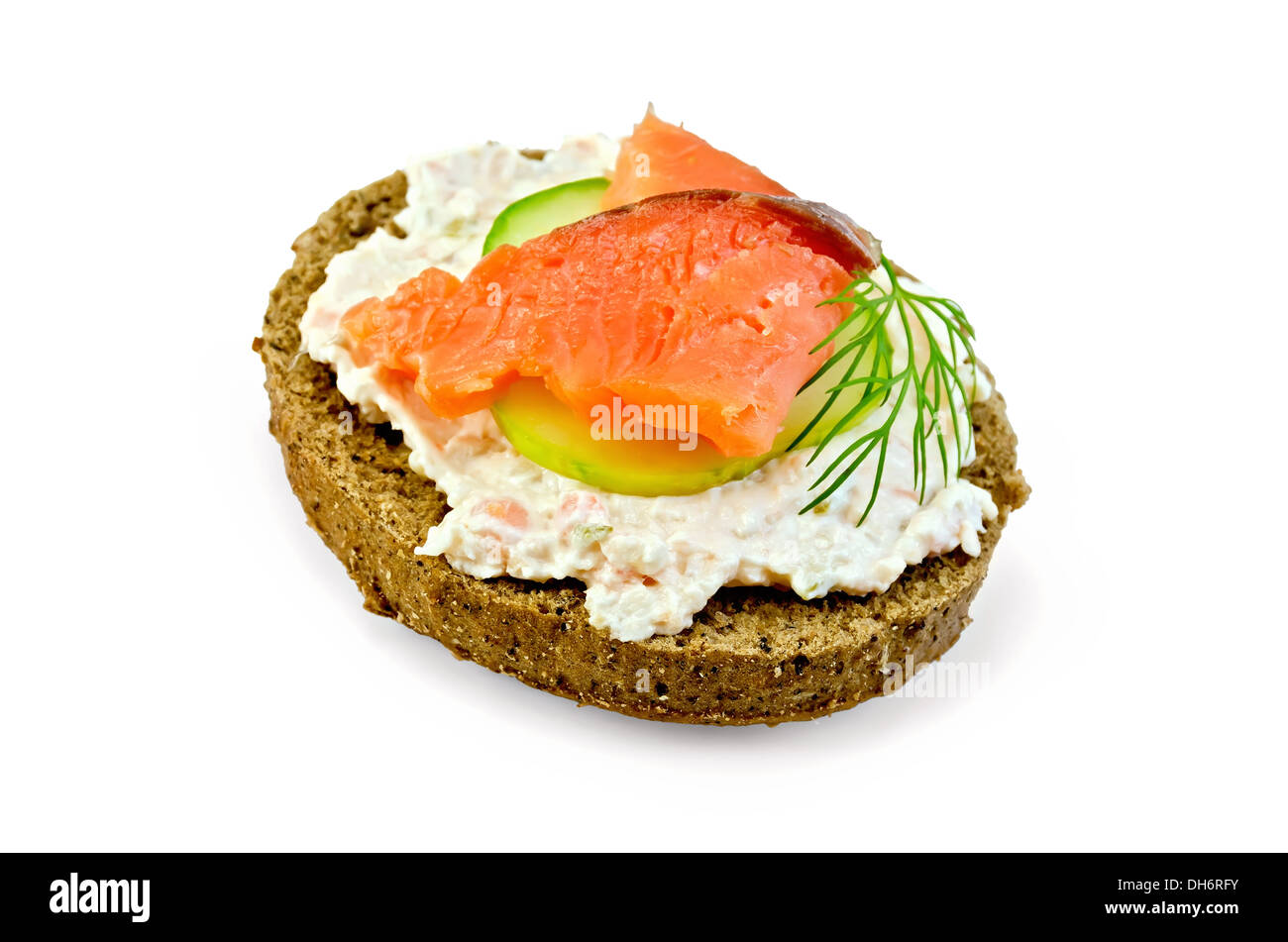 Sandwich of rye bread with cream, cucumber, dill and salmon isolated on ...