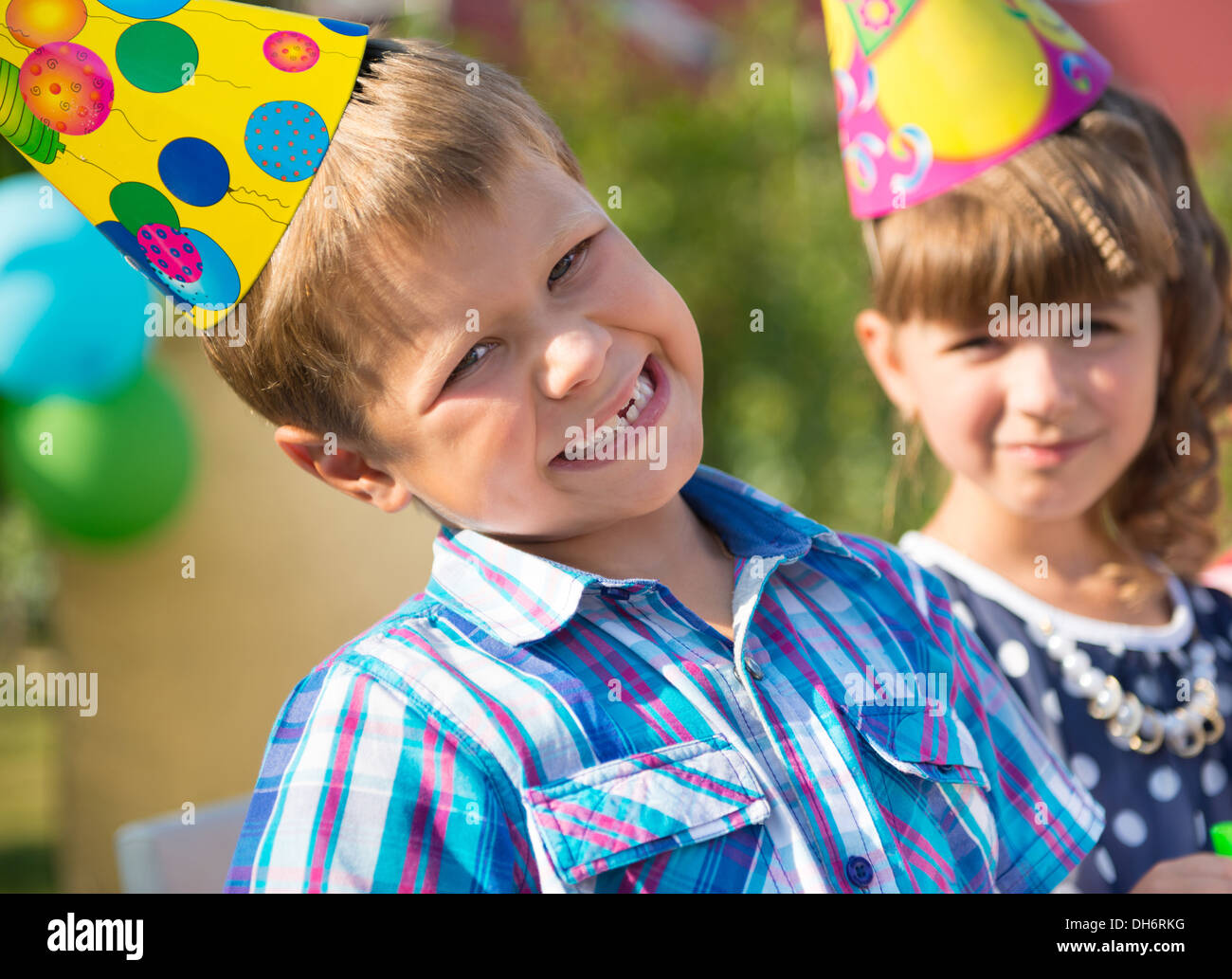 Two happy children having fun at birthday party Stock Photo - Alamy