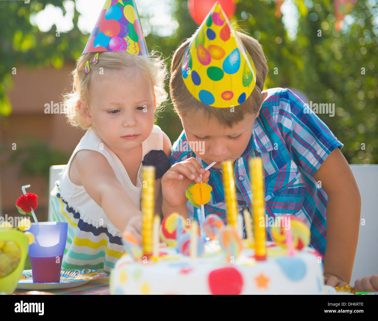 Two happy children having fun at birthday party Stock Photo - Alamy