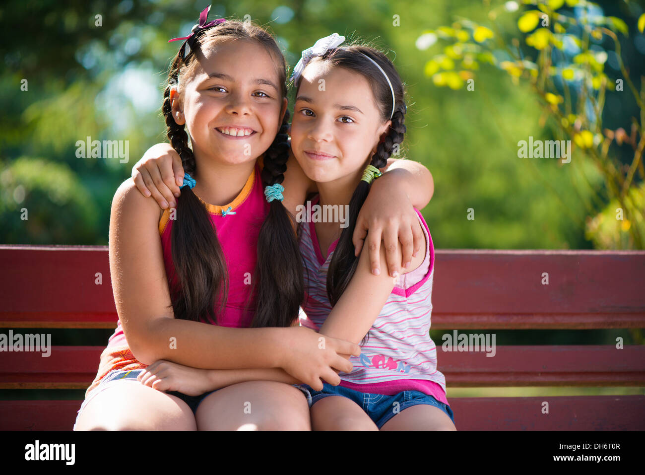 Image of two happy sisters having fun in the park Stock Photo - Alamy