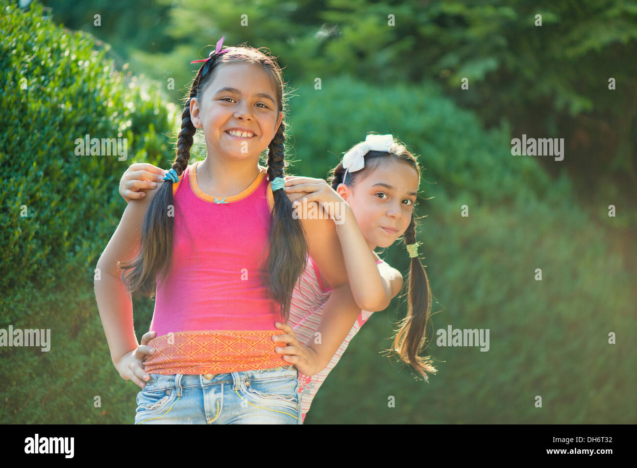 Image of two happy sisters having fun in the park Stock Photo - Alamy