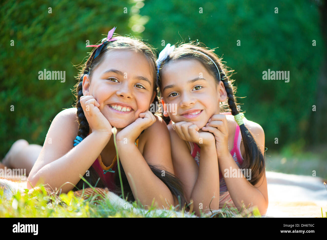 Image of two happy sisters having fun in the park Stock Photo - Alamy